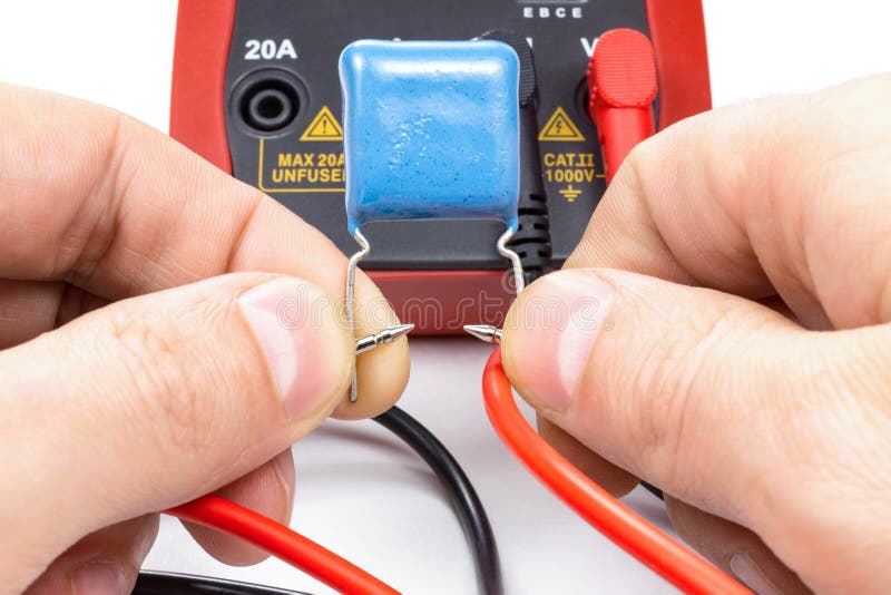 Testing Capacitor with Multimeter on a White Background Stock Photo ...