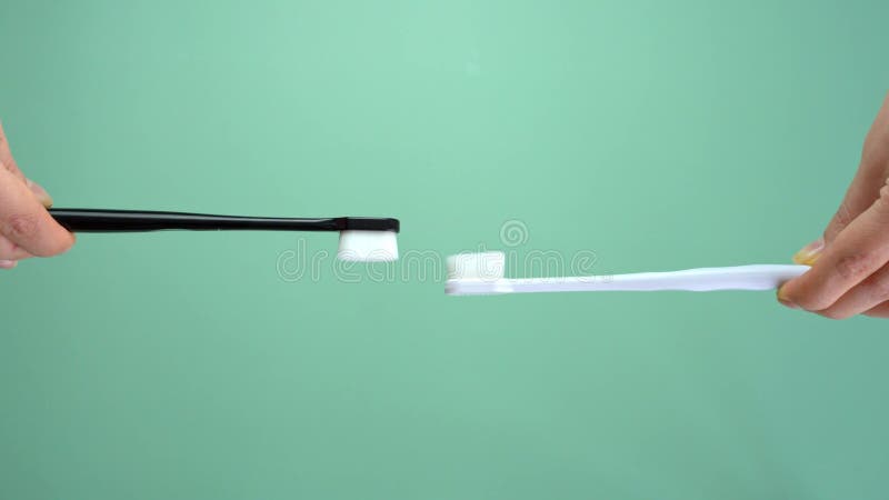 Testing a New Toothbrush. Scratch Two Magic Toothbrushes Together Stock ...