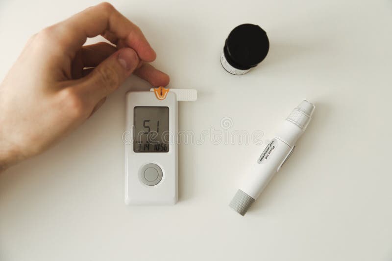 Testing Normal Blood Sugar with Glucometer. Man Hand and Electronic ...