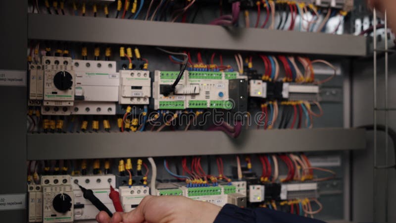 Electrician Tests Switchboard at Substation, in Gear Checking Voltage ...