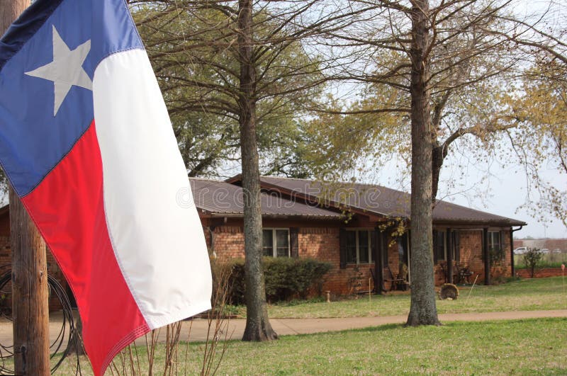 Texas Flag with Brick Ranch House in Background Stock Photo - Image of ...