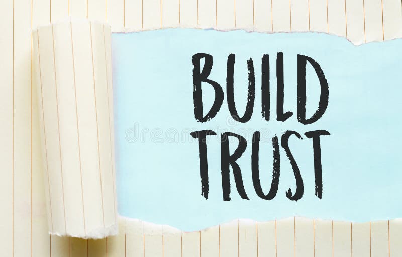 The Text BUILD TRUST Appearing Behind Torn White Paper Stock Photo ...