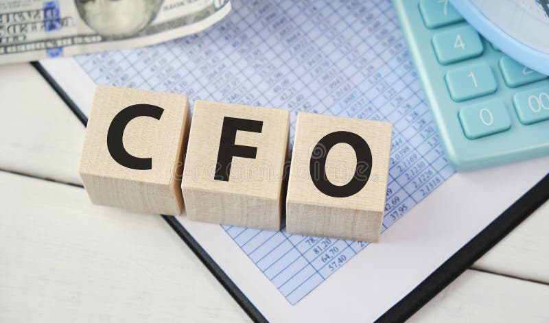 Text CFO on a Wooden Cube Blocks on Notepad Background Near Pen and ...