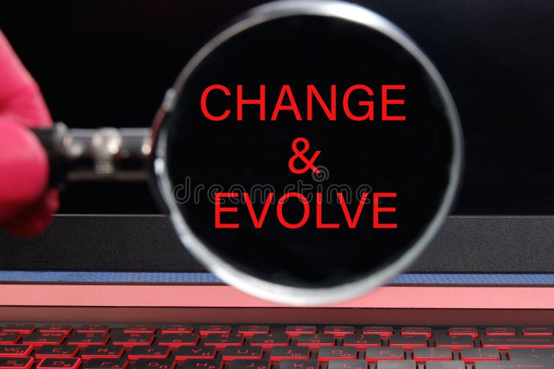The Text CHANGE EVOLVE Written through a Magnifying Glass on a Black ...