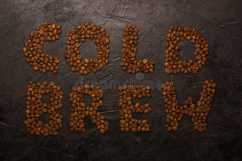Text Cold Brew Laid Out from Coffee Beans on a Dark Concrete Background ...