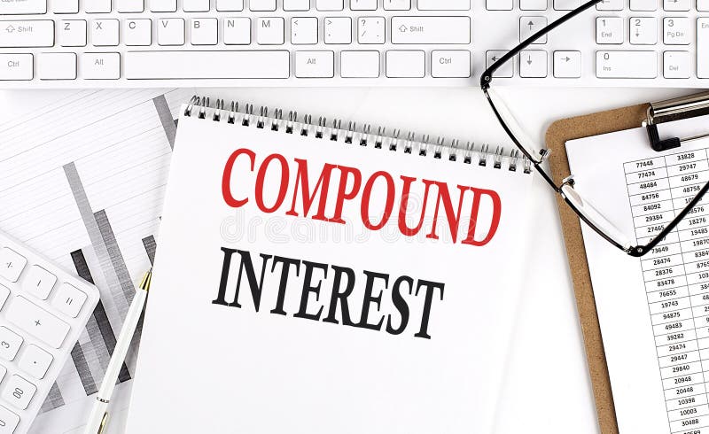 Text COMPOUND INTEREST on Office Desk Table with Keyboard, Notepad and ...