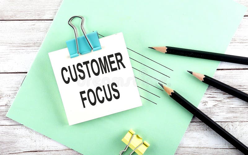 Text CUSTOMER FOCUS on the Short Note with Pencils on the Wooden ...