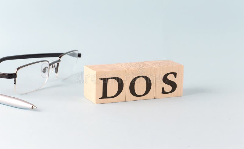 Text DOS - Disk Operating System - Written on the Wooden Cubes on Blue ... Text DOS - Disk Operating System - Written on the Wooden Cubes on Blue ...