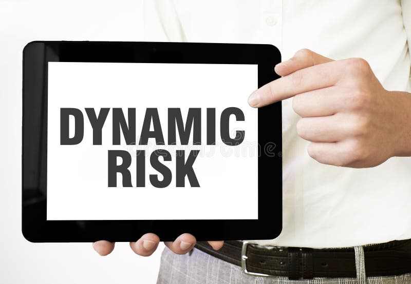 Text DYNAMIC RISK on Tablet Display in Businessman Hands on the White ...