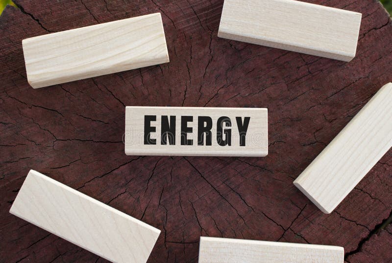 The Text ENERGY is Written on a Wooden Cube Lying on an Old Tree Stump ...