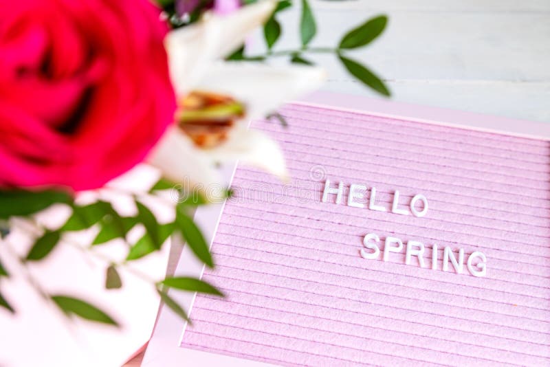 Text Hello Spring on Pink Letter Board and Bouquet of Colored Flowers ...