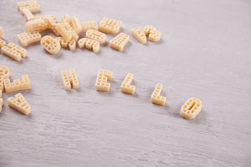 Text Hello Written with Macaroni in the Form of Letters on Grey Wooden ...