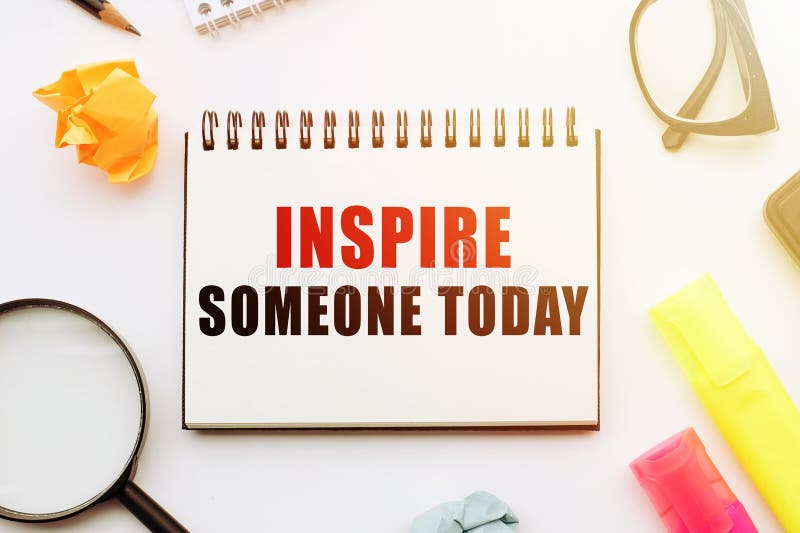 Text INSPIRE SOMEONE TODAY in Notebook on White Table with Office Tools ...