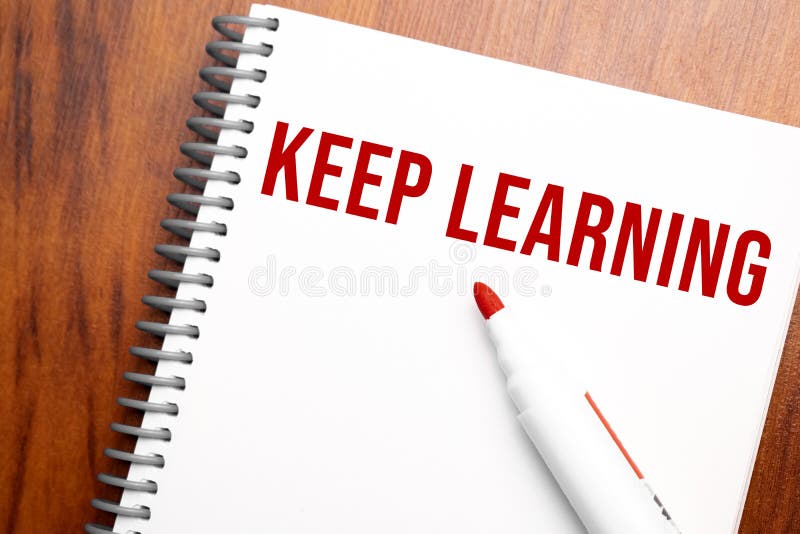 Text Keep Learning Written in Notepad, Office Wood Table from Above ...