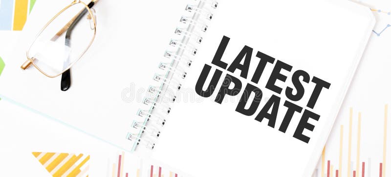 Text LATEST UPDATE on White Notepad, Glasses, Graphs and Diagrams Stock ...