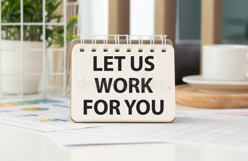 Text Let Us Work for You on Notebook Page on Wooden Table in Office ...