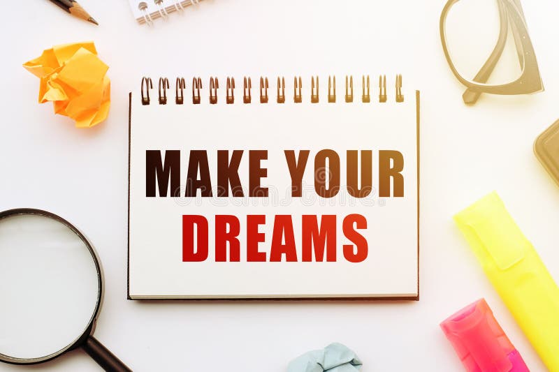 Text MAKE YOUR DREAMS in Notebook on White Table with Office Tools ...