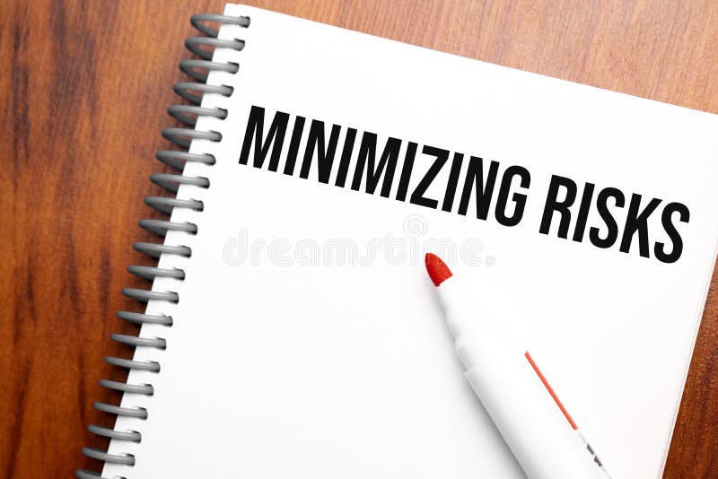 Text Minimizing Risks Written in Notepad, Office Wood Table from Above ...