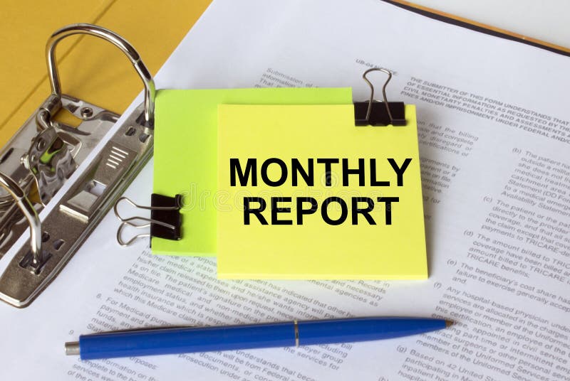Text Monthly Report on a Yellow Sticker that is in a Folder with ...