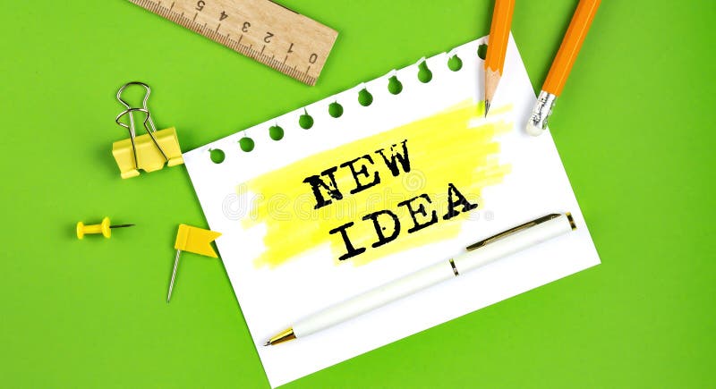 Text NEW IDEA Sign Showing on the Green Background with Office Tools ...