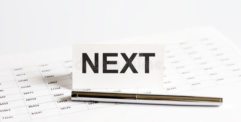 Text NEXT on Stickers,pen on the Background of Documents. Financial ...