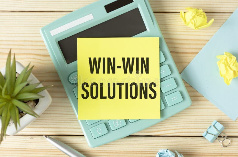 Notepad Win-Win Solutions on Calculator White Table Stock Image - Image ...