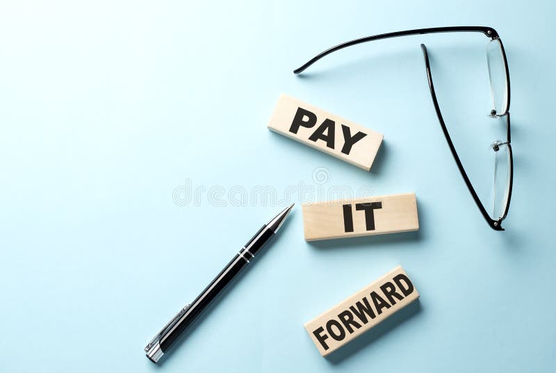 Text PAY it FORWARD Concept on Wooden Block on the Blue Background ...