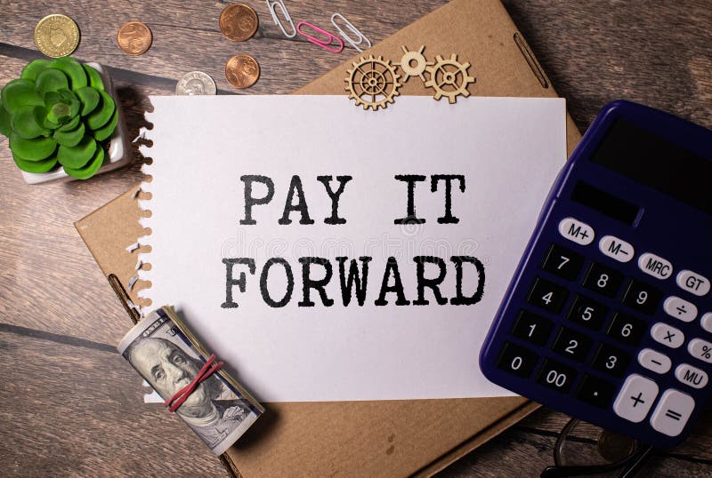 Text PAY it FORWARD on a Notebook with Office Tools on White Background ...
