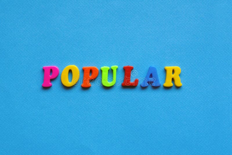 Text Popular from Plastic Colored Letters on Blue Paper Background ...