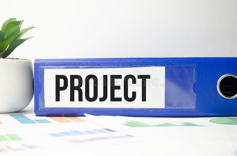 Text PROJECT is Written on a Folder Lying on a Stack of Papers with a ...