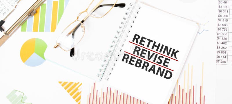 Text RETHINK REVISE REBRAND on White Notepad, Glasses, Graphs and ...