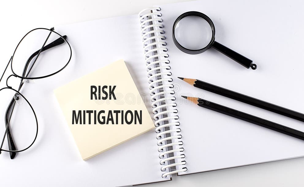 Text RISK MITIGATION on the Sticker with Keyboard , Pencils and Office ...