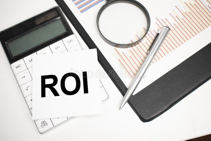 Text Roi on Easel with Office Tools and Paper.Top View Stock Image ...
