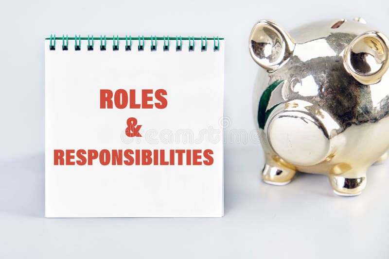 Text Roles and Responsibility on a Notebook in Front of a Gray ...