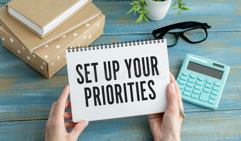 Text SET UP YOUR PRIORITIES on White Paper on Clipboard with Chart and ...