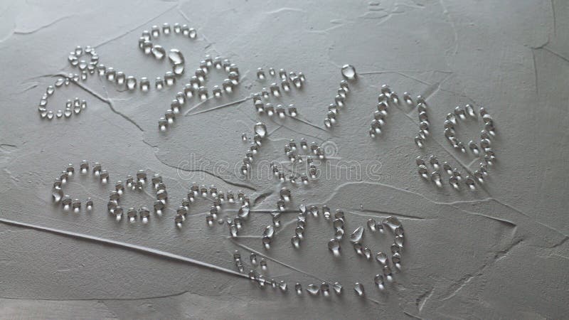 Text Spring is Coming Written with Water Droplets on Gray Concrete ...