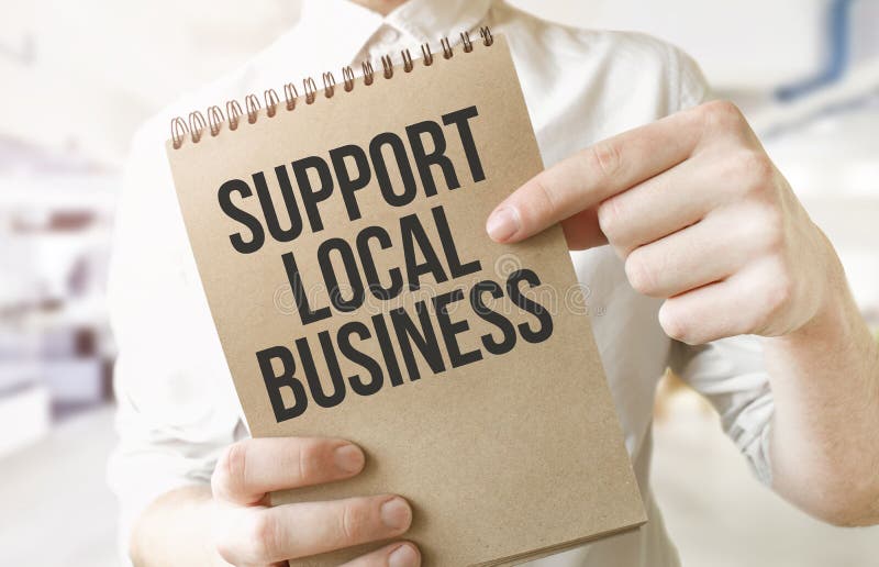 Text Support Local Business on Brown Paper Notepad in Businessman Hands ...