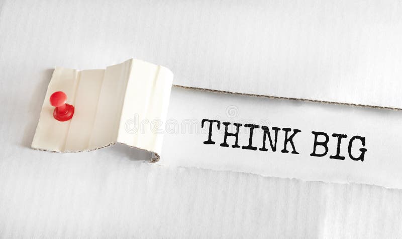 The Text THINK BIG Appearing Behind Torn Yellow Paper Stock Photo ...
