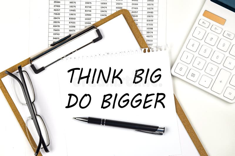 Text THINK BIG DO BIGGER on the White Paper on Clipboard with Chart and ...