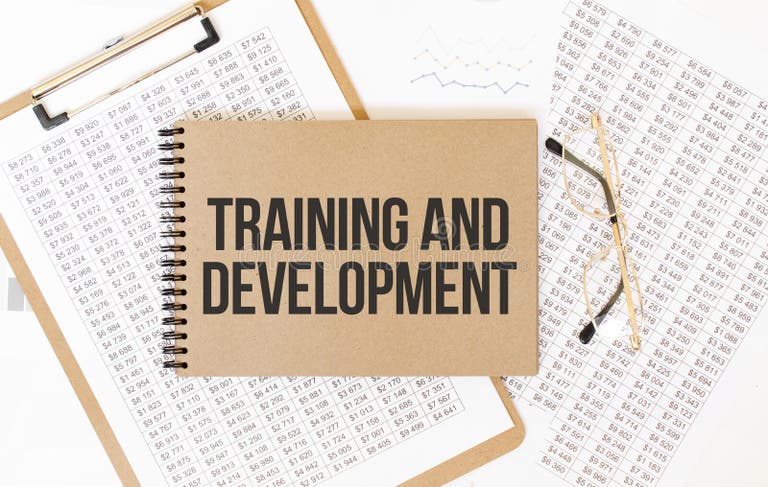 Text Training and Development on Brown Paper Notepad on the Table with ...