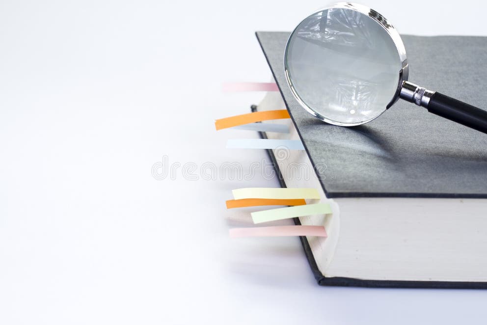 Textbook with Multicolor Bookmarks and Magnifying Glass Stock Photo ...