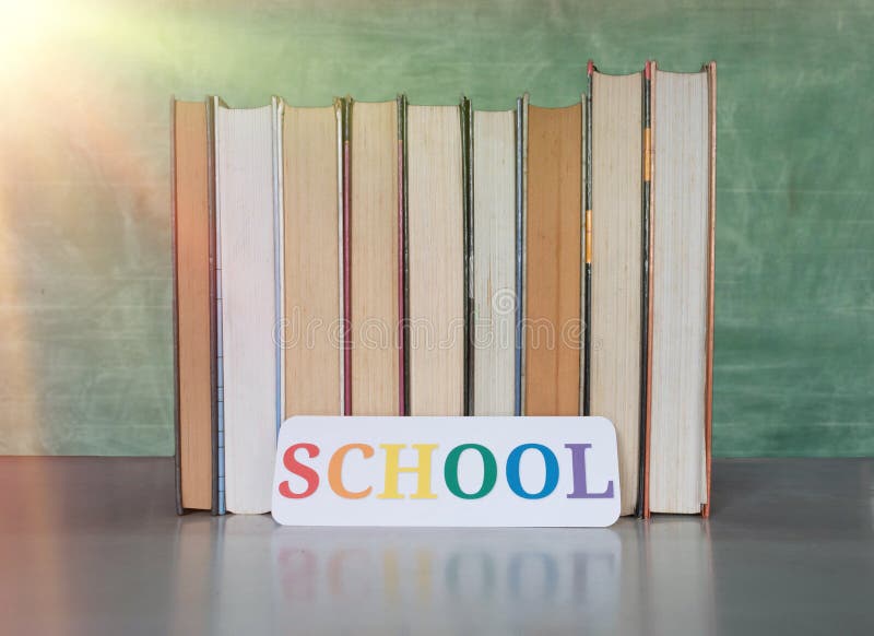 Textbooks on Desk in Front of Blurred Blackboard Stock Photo - Image of ...