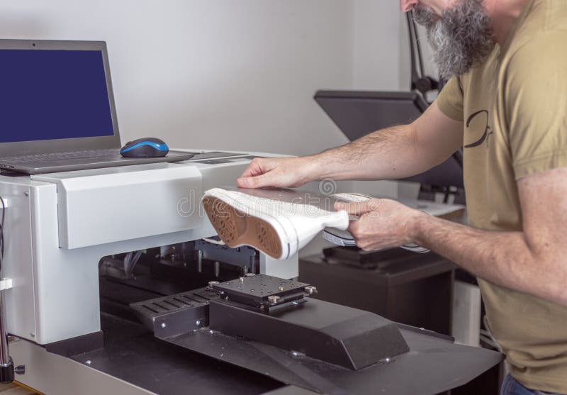 Textile Printing Worker Preparing Machine for Customization in Sneakers ...