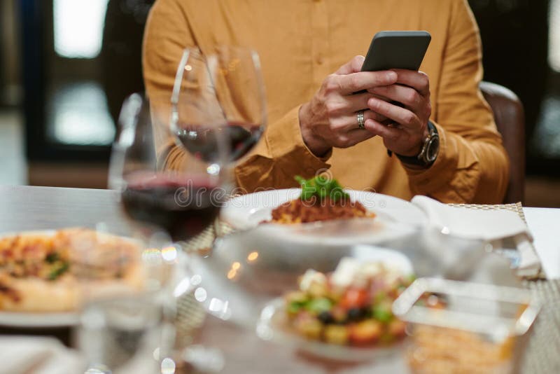 Texting Man Eating in Restaurant Stock Image - Image of serious, check ...