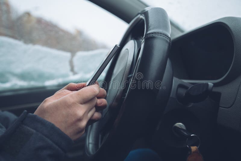 Texting in Parked Car while the Snow is Falling Outside Stock Photo ...