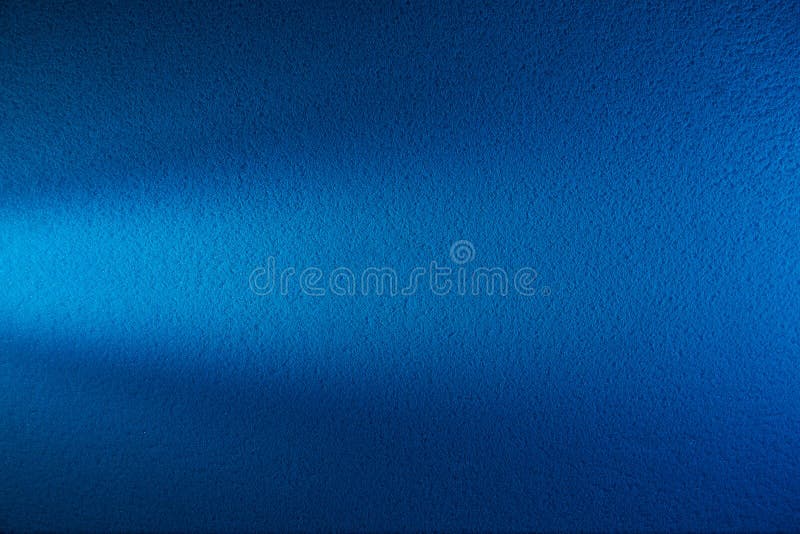 On a Textural Blue Background, a Diffused Ray of Light Shines from the ...