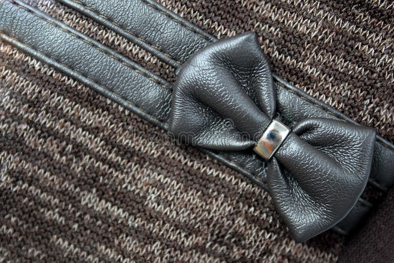 Brown Leather Bow Sewn Onto Knit Fabric Stock Photo - Image of ...