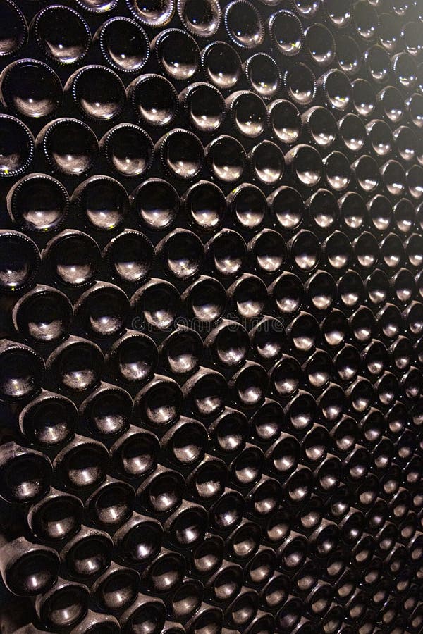 Texture of Bottles of Red Wine Stacked in the Cellar. Vertical View ...