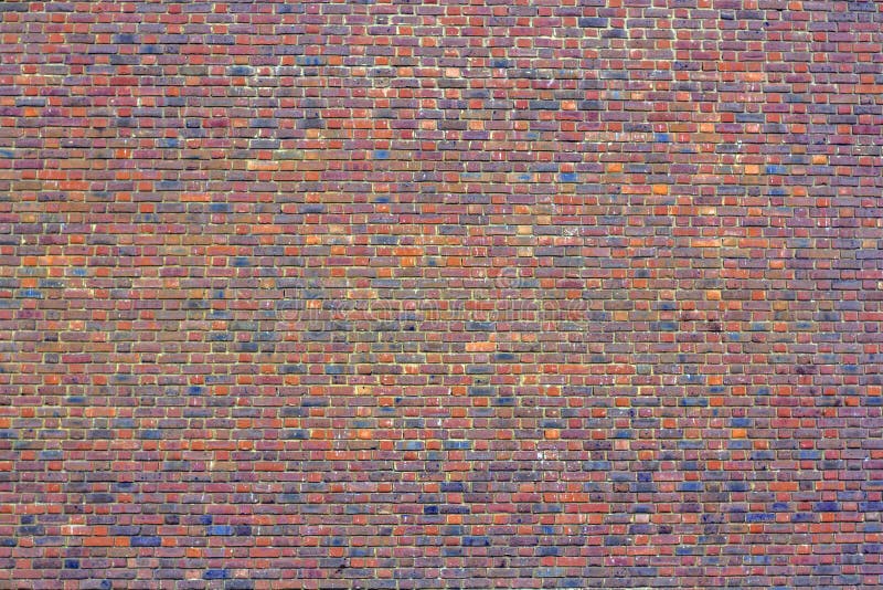 A Large European Style Brick Building among Green Bushes and Trees ...