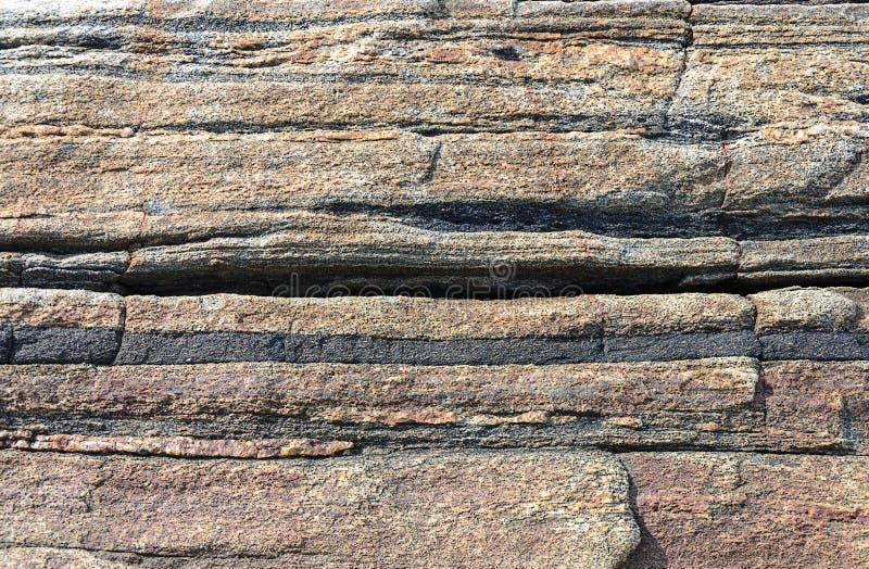 Layered basalt rock cliff stock image. Image of ground - 76537123